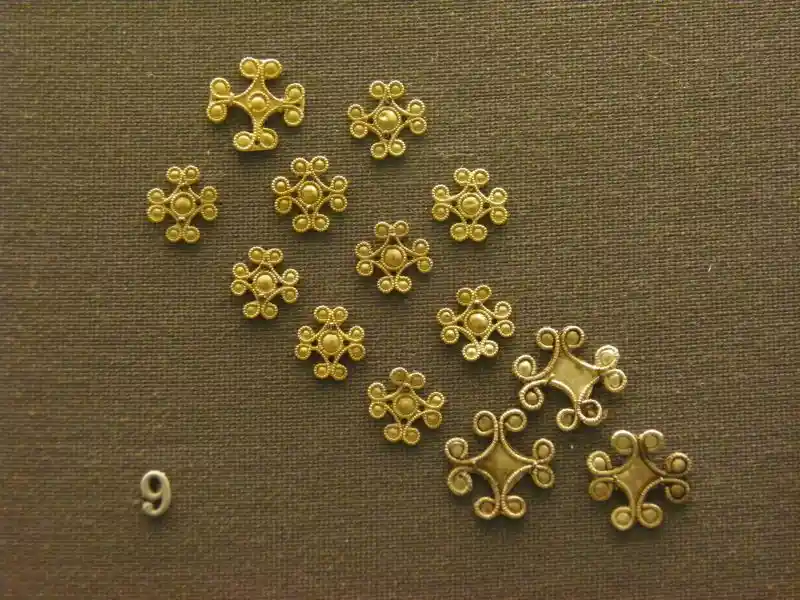 Gold ornaments curly tipped crosses